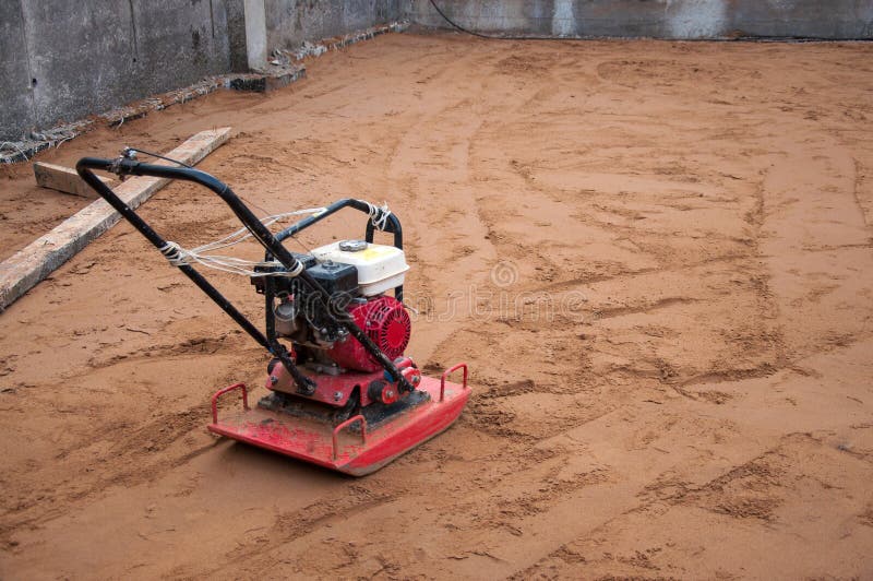 Worker On Construction Site With Vibratory Compactor For Soil ...
