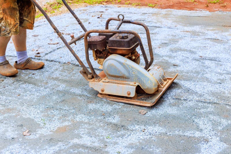 Vibratory Tamping Machine Compacting Sand during Construction of a Pool ...