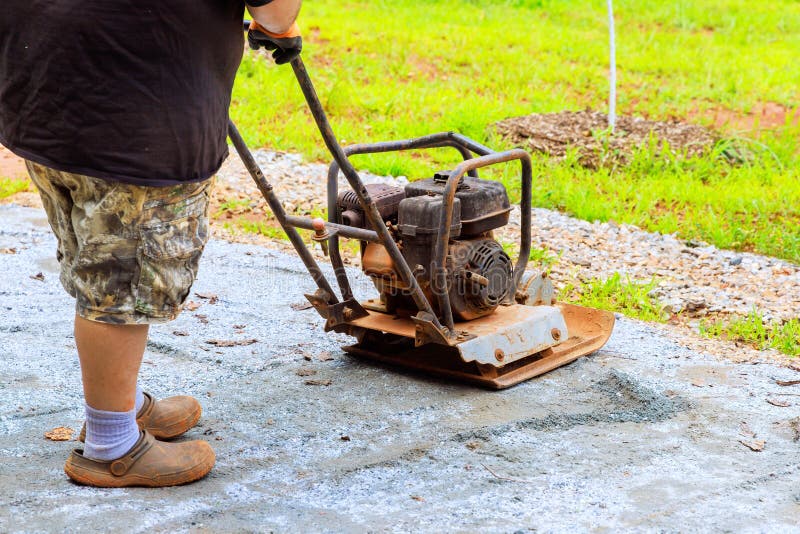 Vibratory Tamping Machine Compacts Sand during Construction of a ...