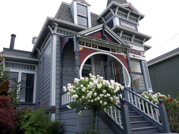 Victorian House with White Rose Bush in Front Stock Photo - Image of ...