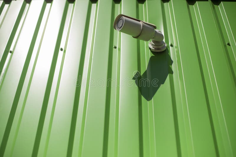 Video Camera on Green Wall. Building Security System Stock Photo ...