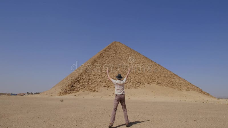 This Video Captures a Man Standing in Front of an Ancient Pyramid Under ...