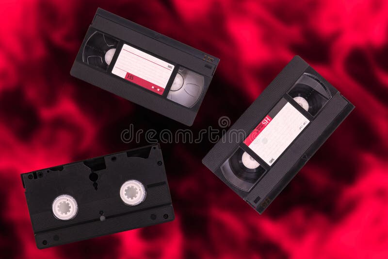 Video Cassettes, VHS, Pal Secam, Red and Black Blurred Retro Background ... Video Cassettes, VHS, Pal Secam, Red and Black Blurred Retro Background ...