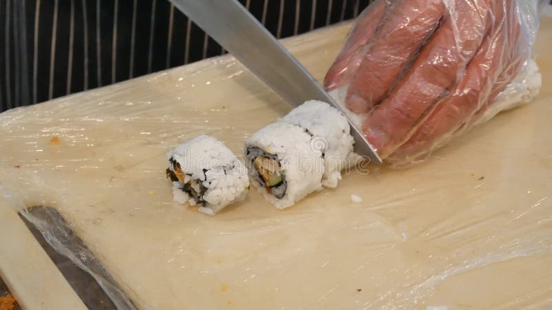 Video of a Chef Skilfully Making Slicing Sushi Using a Bamboo Mat ...