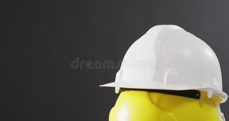 Video of Close Up of Colourful Building Helmets on Gray Background ...