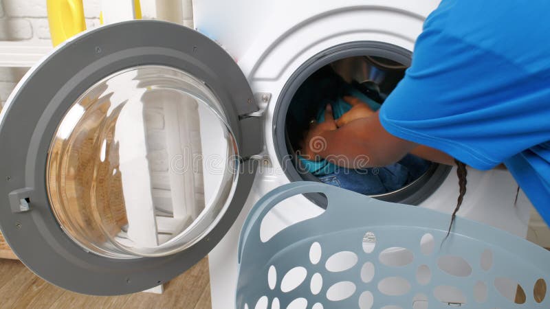 Opening a Front-Loading Washing Machine Door in the Kitchen Stock ...