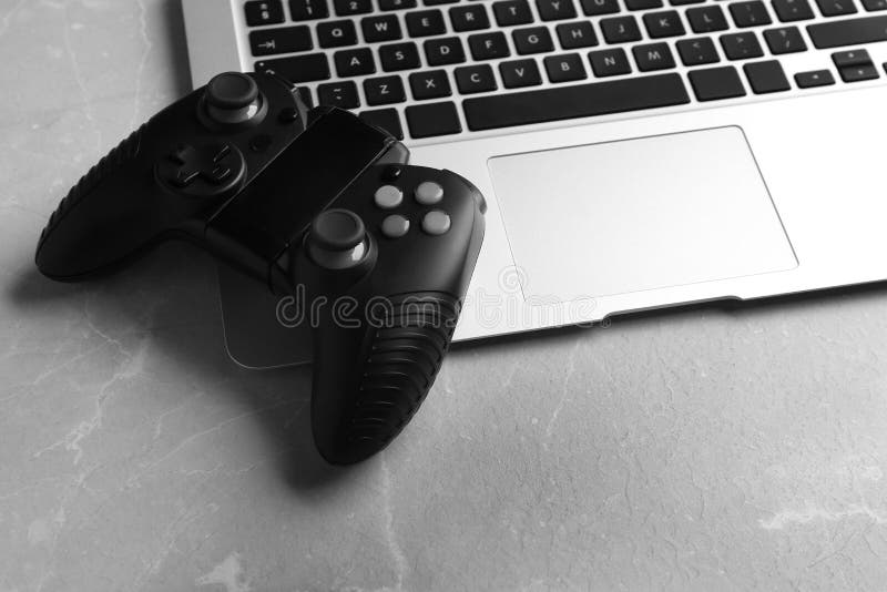 Video Game Controller and Laptop on Table Stock Photo - Image of ...