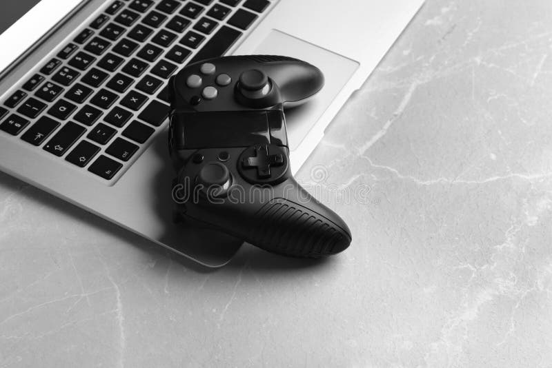 Video Game Controller and Laptop on Grey Table. Stock Image - Image of ...