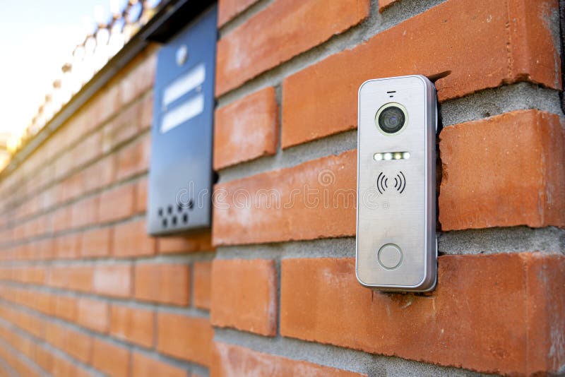 Video Intercom Outdoors. Call with a Video Camera on a Red Brick Fence ...