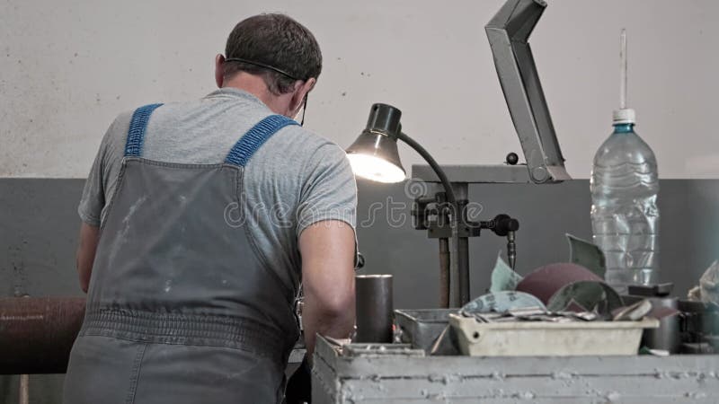 Video 4k. a Detailed View of a Diligent Worker Operating a Lathe ...
