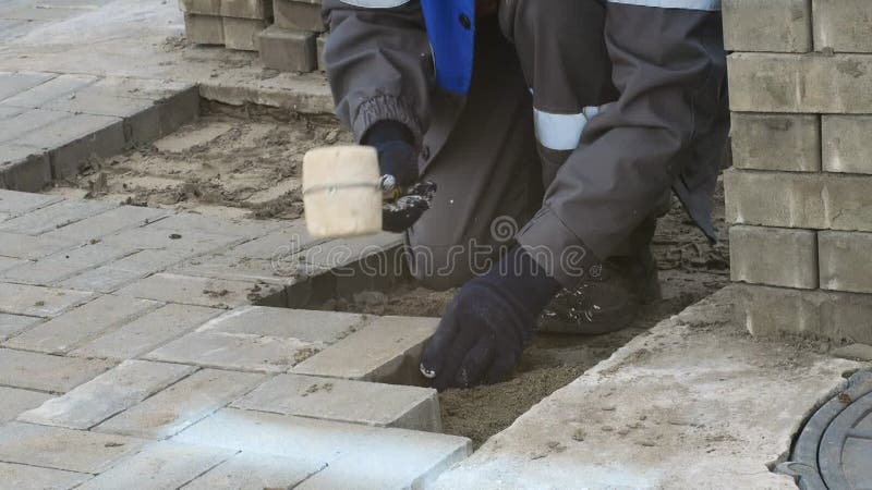 Video 4k Resolution. Bricklayer Lays Brickwork or Paving Slabs on ...