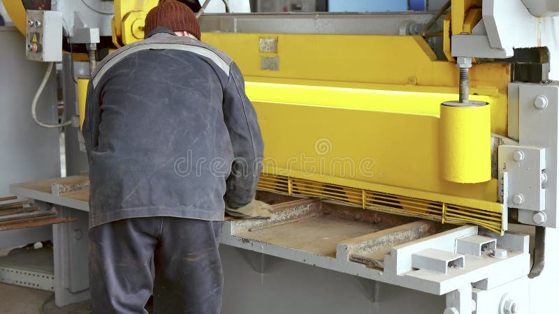 Video 4k Resolution. Worker Works on Mechanical Guillotine Machine in ...