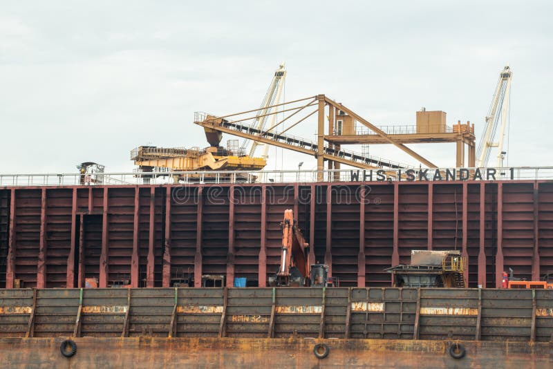 Loading Coal from Cargo Barges Onto a Bulk Carrier Using Ship Cranes ...