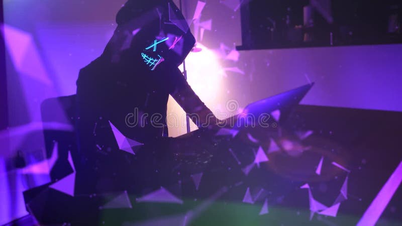 Hacker Wearing a Glowing Mask Sitting in a Dark Room and Coding on His ...