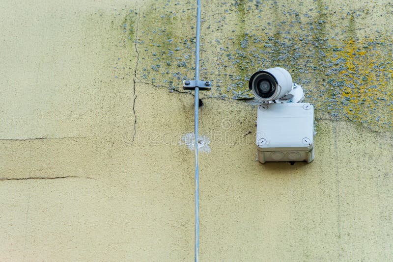 A Video Surveillance Camera is Installed on the Facade of a Building ...