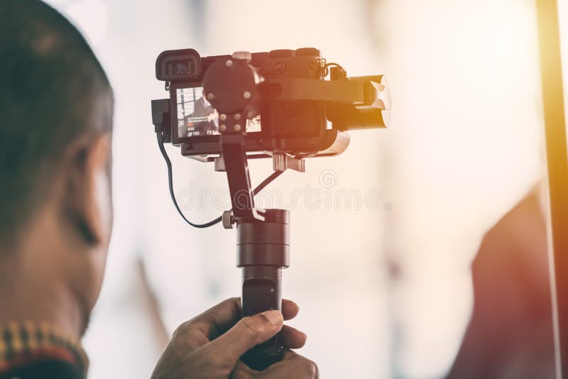 Videographer Recording Video with Mirrorless Digital Camera on Gimbal ...
