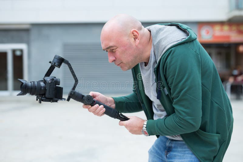 Videographer Recording Video on Site with Mirrorless Camera Using ...