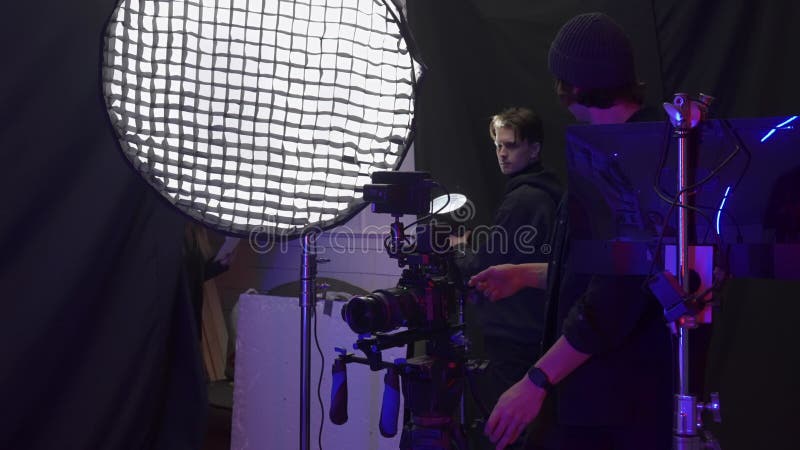 The Videographer Sets Up the Camera, and the Lighting Technician Sets ...