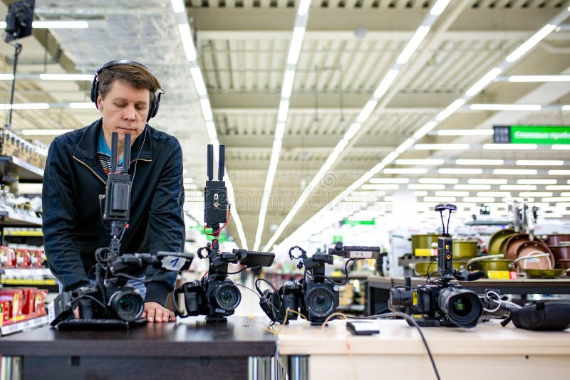 Videographer Shooting a Film or a Television Program in a Studio with a ...