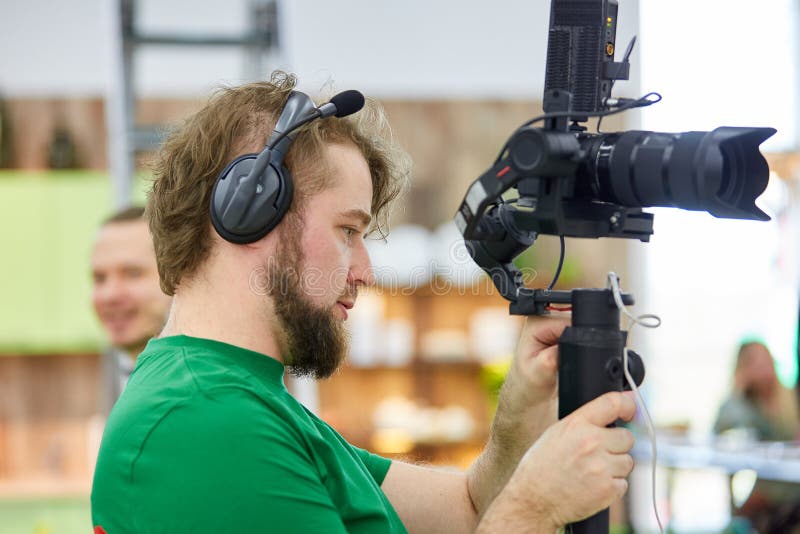 Videographer Shooting a Film or a Television Program in a Studio with a ...