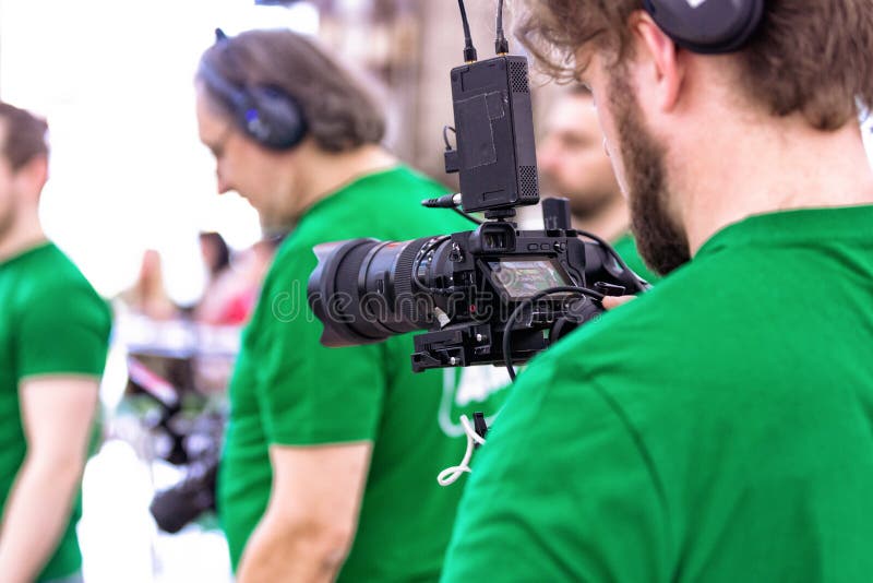 Videographer Shooting a Film or a Television Program in a Studio with a ...
