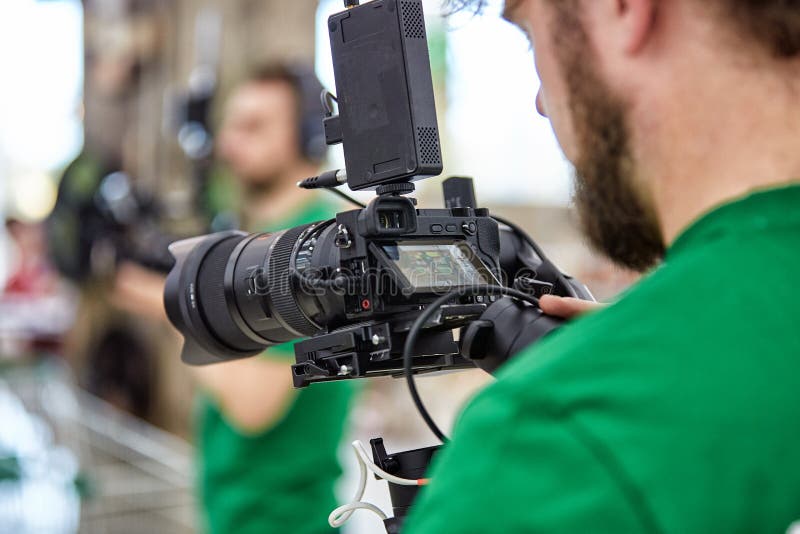 Videographer Shooting a Film or a Television Program in a Studio with a ...