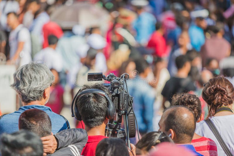 Videographer taking videos editorial photography. Image of camera ...