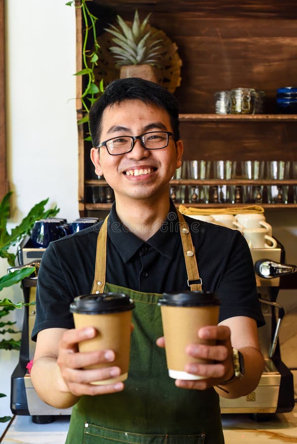 Vietnamese Smiling Waiter Holding Paper Cups with Coffee in a Cafe ...