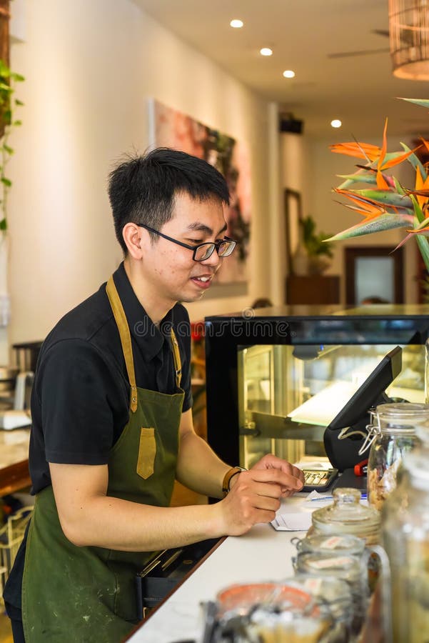 Vietnamese Waiter Working in Counter with Cashier Machine in a Cafe ...