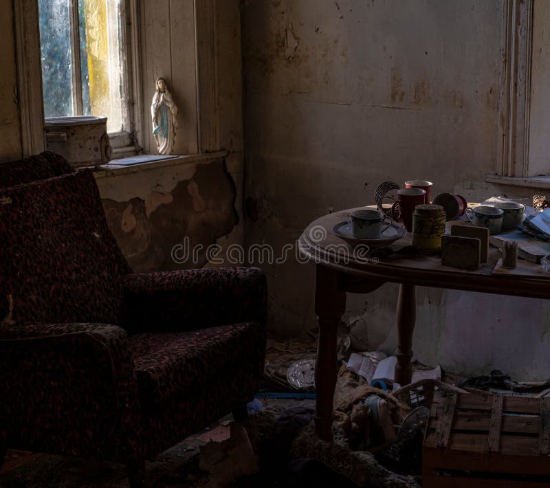 View of an Abandoned, Dirty Home and a Religious Statue on a Windowsill ...
