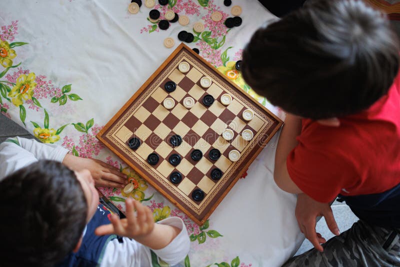 View from Above of a Checkers Game Board and Two Children Playing ...