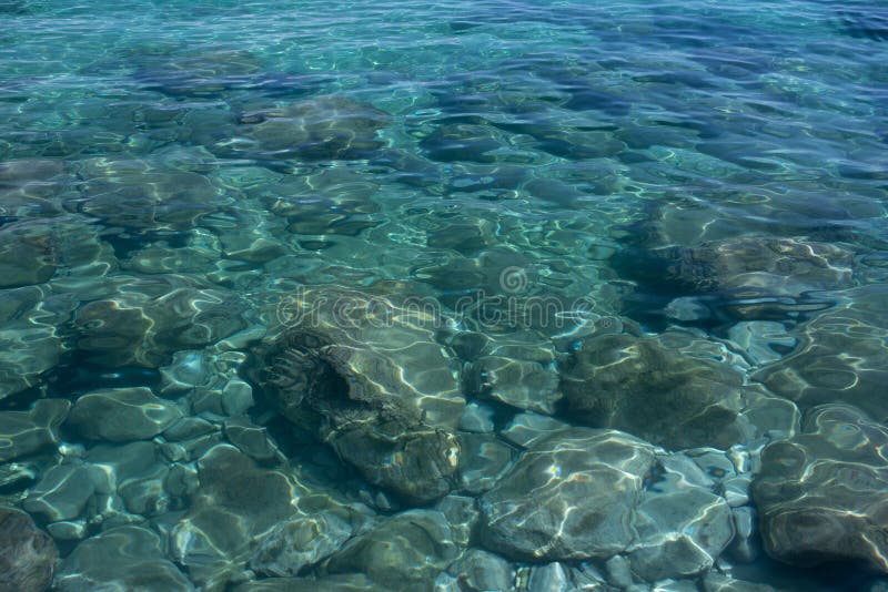A View from Above through Clear Water. Rocks Lie on the Seabed. the Sun ...