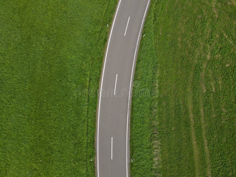 View from Above of a Curved Road between Grass Fields in the Landscape ...