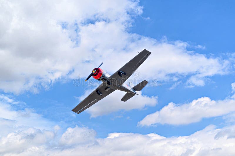 Aerobatic Plane (aerodyne), in Flight Under a Blue Sky with White ...
