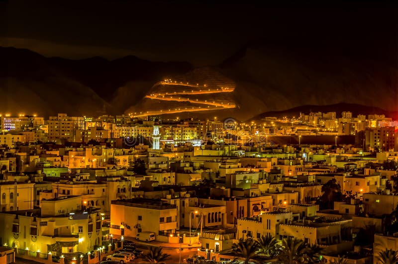 A View Across the Rooftops Towards the Distant Mountains at Night in ...