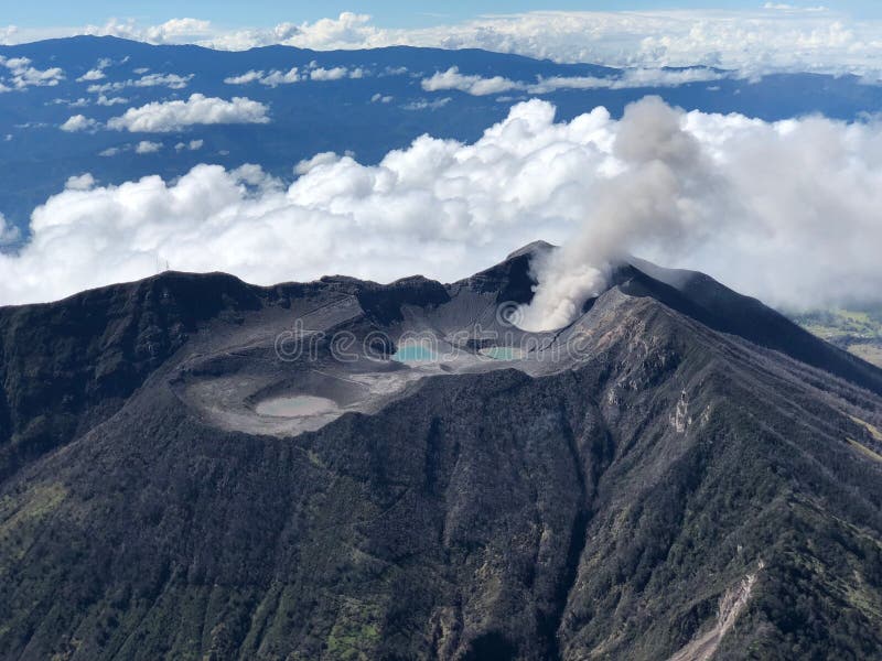 View of an Active Volcano with Billowing Clouds in the Background Stock ...