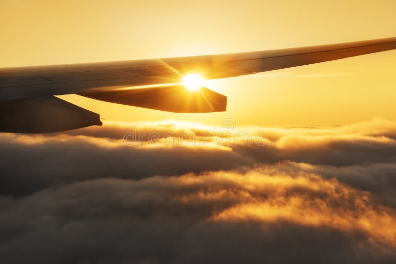 View from an Airplane Window. Incredible Clouds at Sunset and the Wing ...