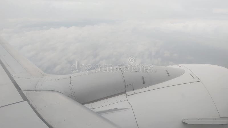 Peaceful Sky View from Airplane Window: Clouds and Plane Wing in Flight ...