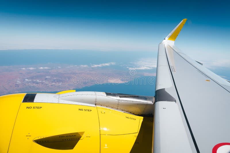 View of Airplane Yellow Engine and Wing in Flight Stock Image - Image ...