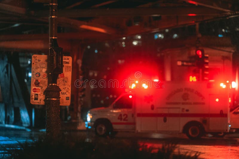 View of an Ambulance Parked Under an Illuminated Overpass at a Busy ...