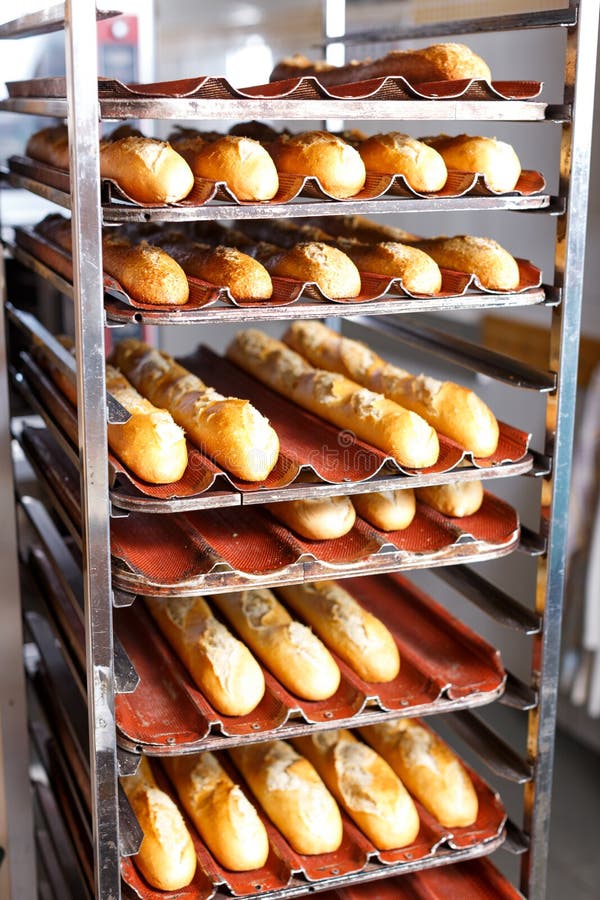 Baked bread on bakery rack stock photo. Image of white - 263937178