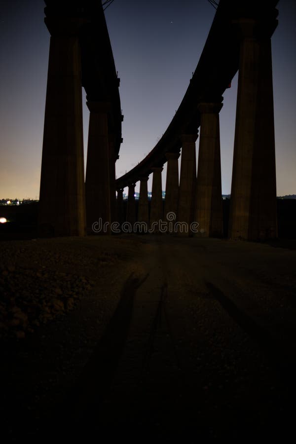View of an Architectural Structure with Rocky Columns at Night with ...