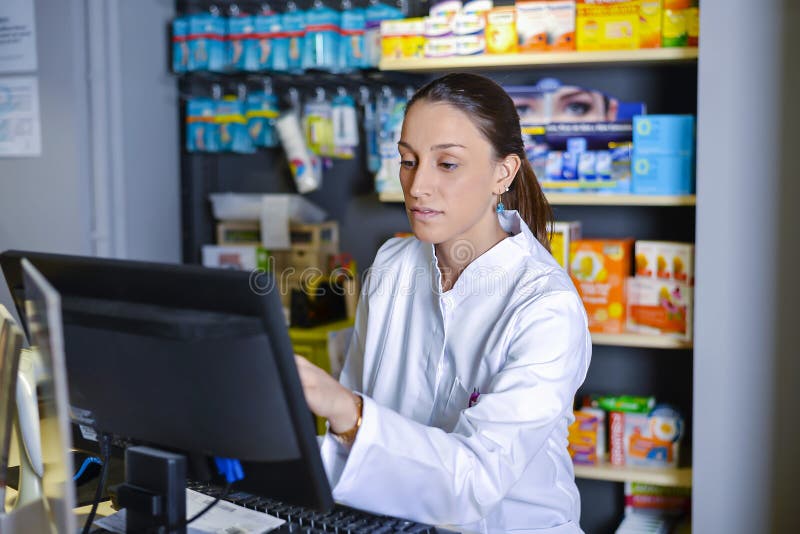 View of an Attractive Pharmacist at Work Stock Photo - Image of desk ...