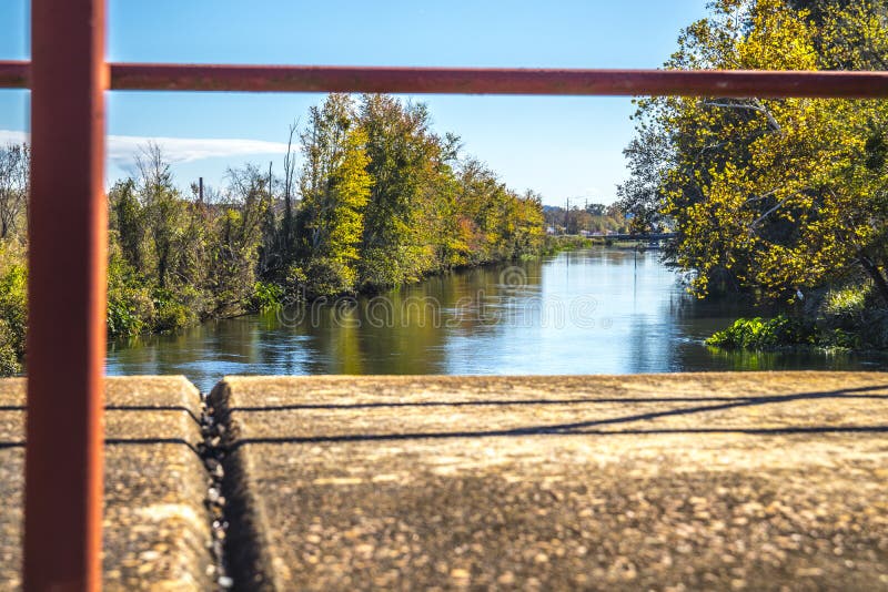 View of the Augusta Canal River through a Bridge Rail Stock Photo ...