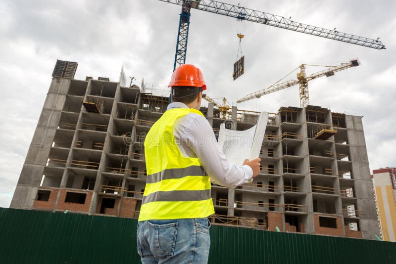 Construction Inspector Posing With Blueprints On Building Site Stock ...
