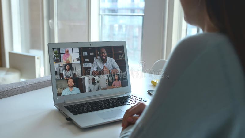 Young Woman Using Laptop for Video Meeting with Group of Diverse People ...