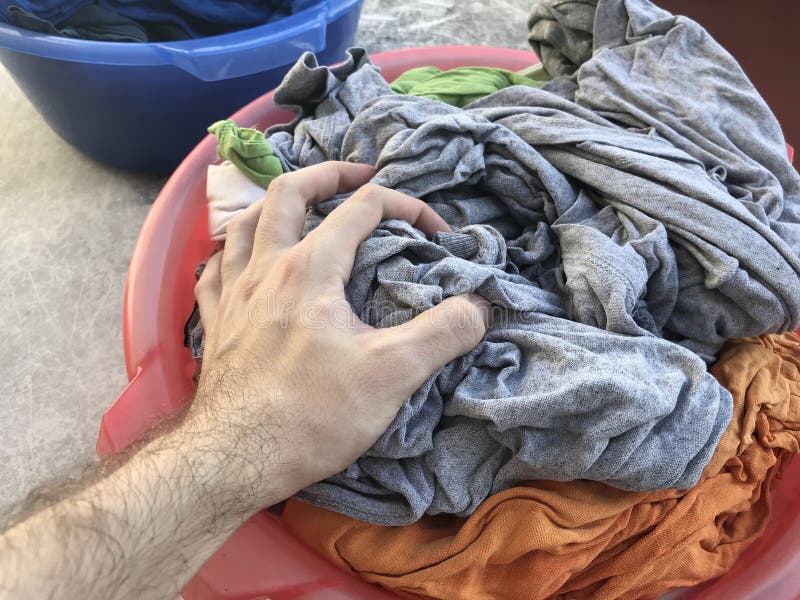Basket Full of Clean Laundry with a Hand Picking Some Clothes Stock ...