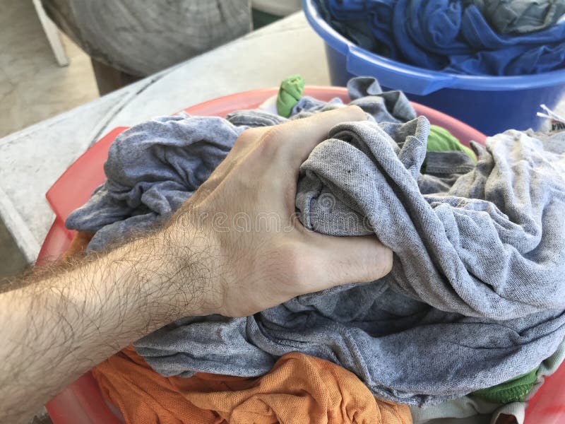 Basket Full of Clean Laundry with a Hand Picking Some Clothes Stock ...