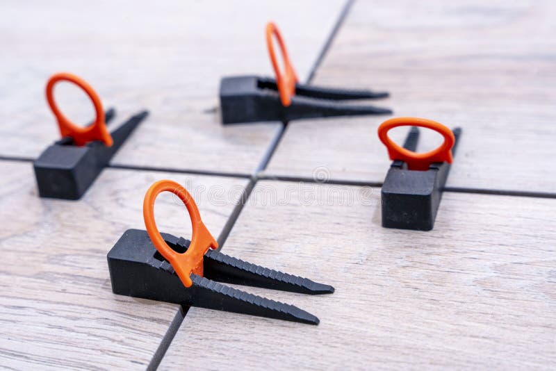 Close-up of the Tile Alignment System Holding Tile in Given Position ...