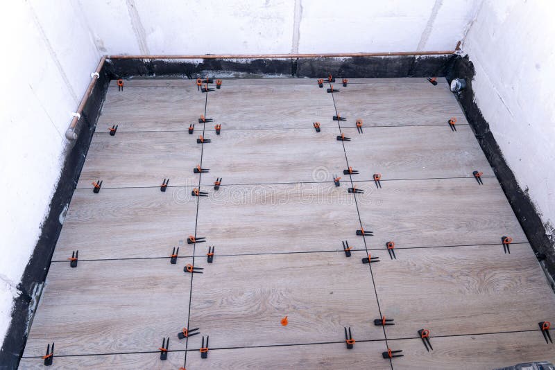 Close-up of the Tile Alignment System Holding Tile in Given Position ...